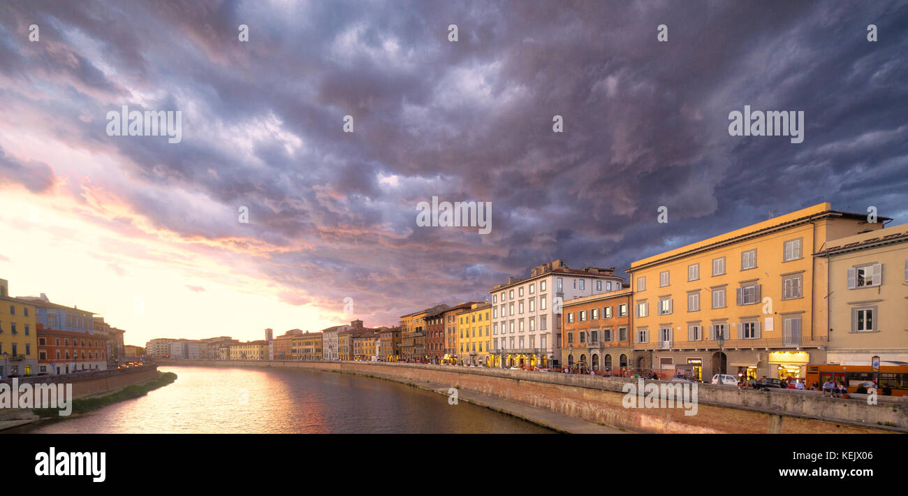 Colorful red and blue scenic sunset sky with clouds on river in Pisa ...