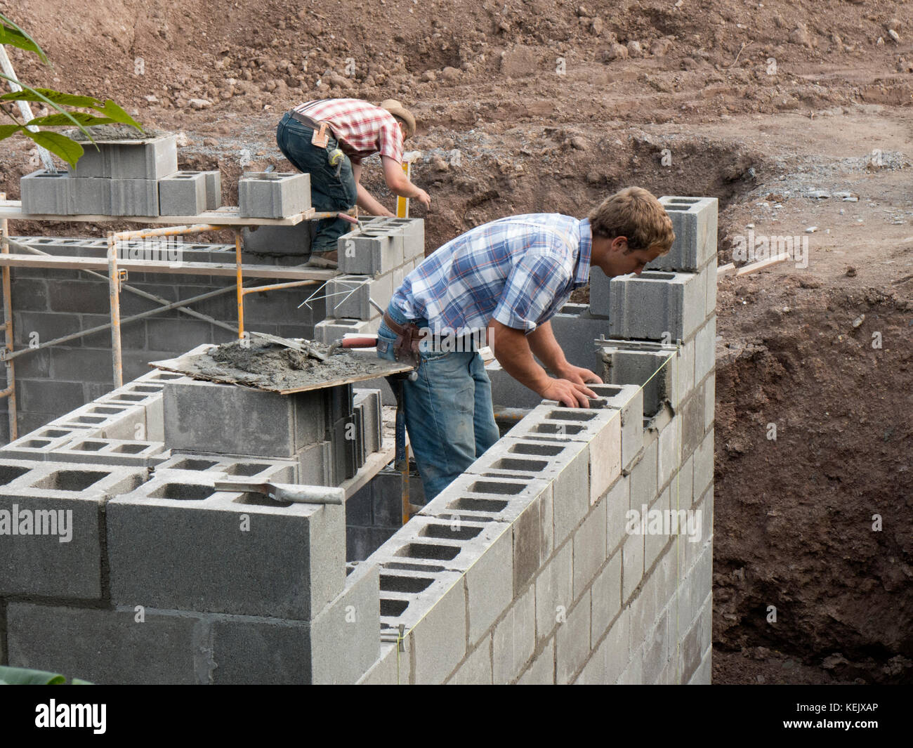 Masons working on new house Stock Photo - Alamy