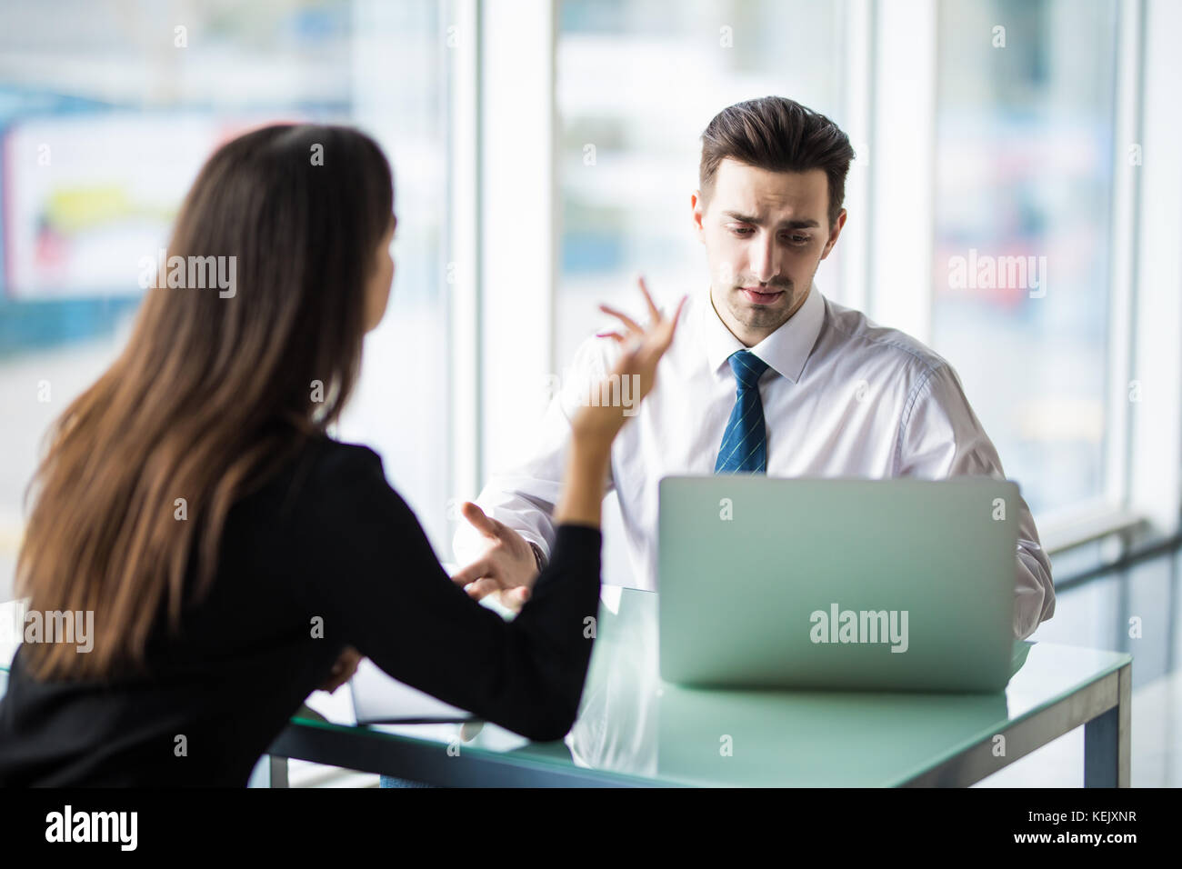 Businesswoman and businessman talking at work in office Stock Photo - Alamy