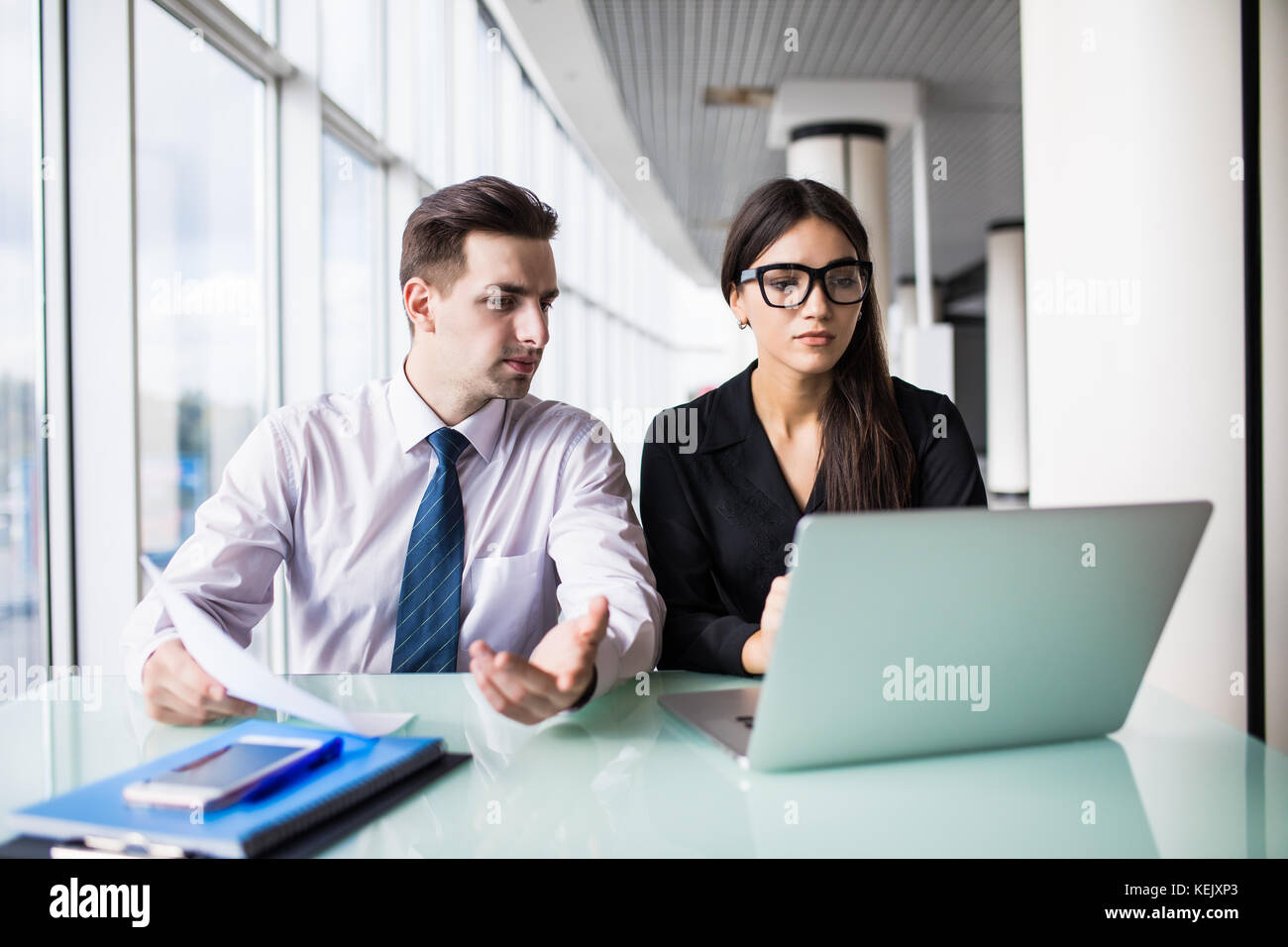 Businesswoman and businessman talking at work in office Stock Photo - Alamy