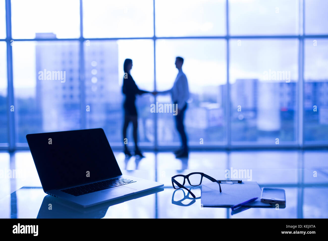 Close up of eye glasses on work desk with chart and laptop at business ...