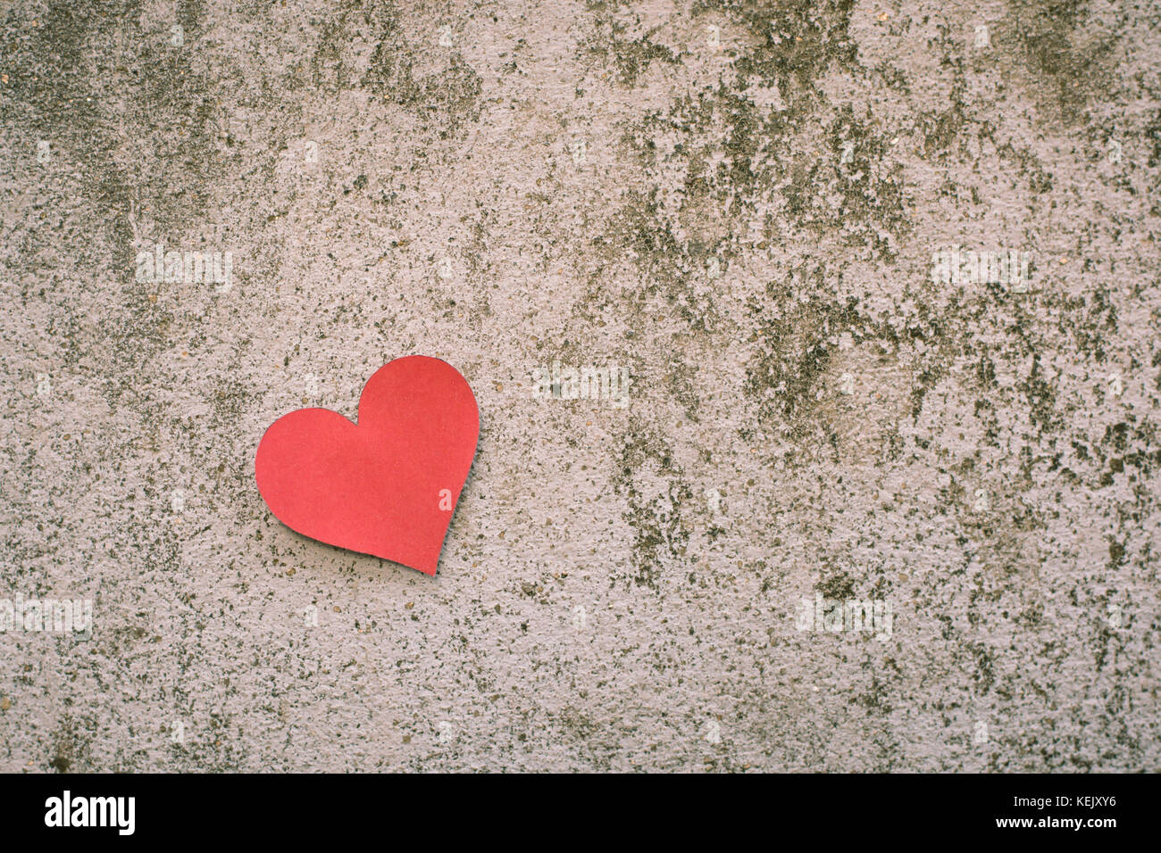 red paper heart shape on concrete background Stock Photo - Alamy