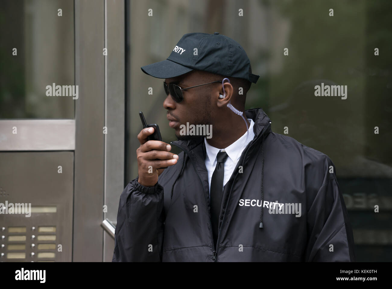 Security guard talking on radio hi-res stock photography and images - Alamy