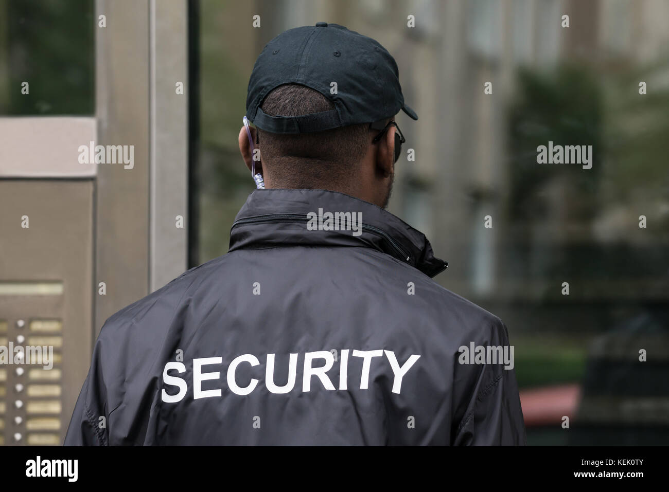 Rear View Of A Male Security Guard Wearing Black Uniform Stock Photo ...