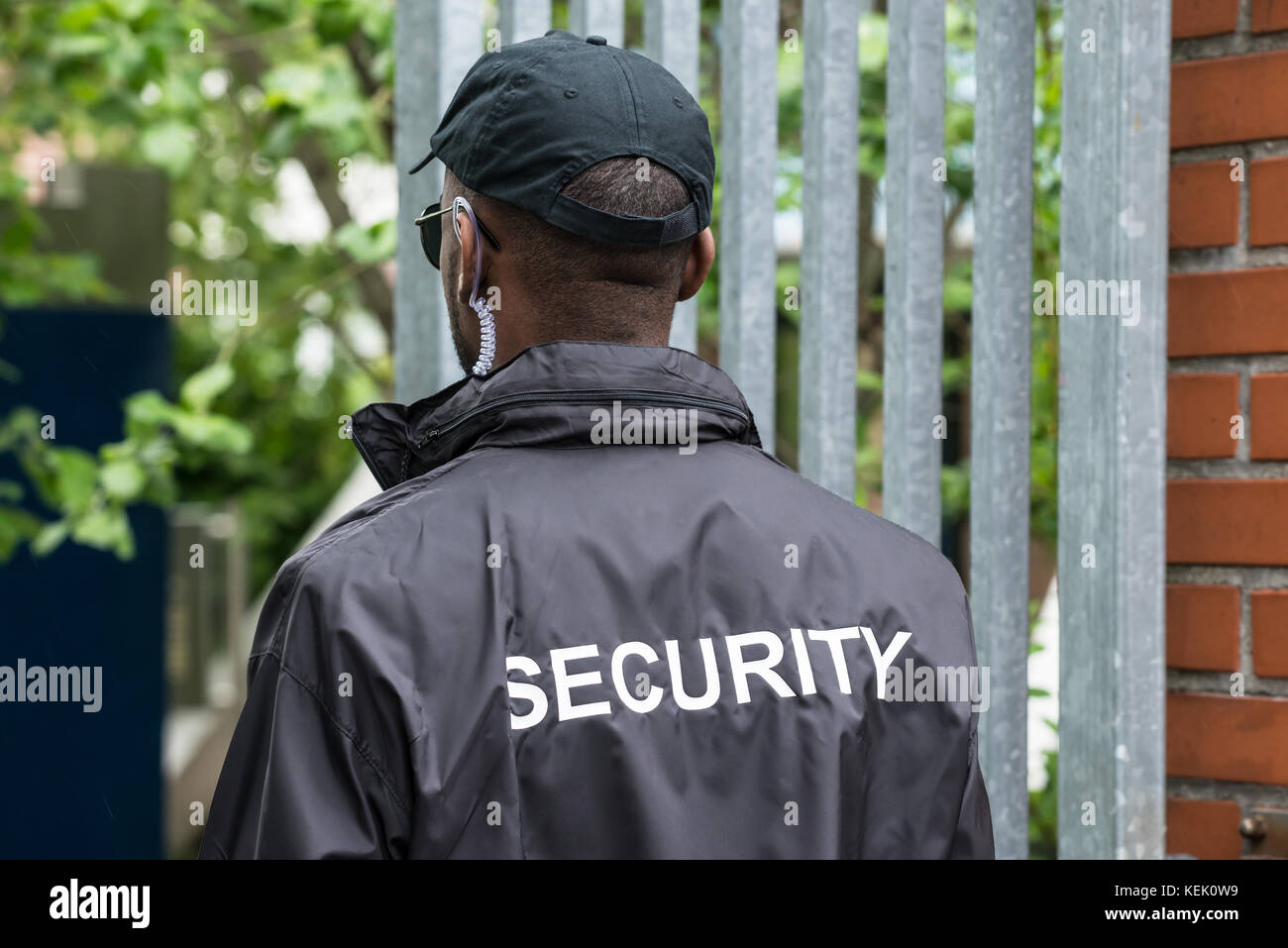 Rear View Of A Male Security Guard Wearing Black Uniform Stock Photo ...