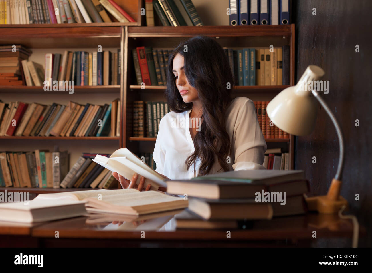 girl is preparing for the exam reading book at the library Stock Photo ...