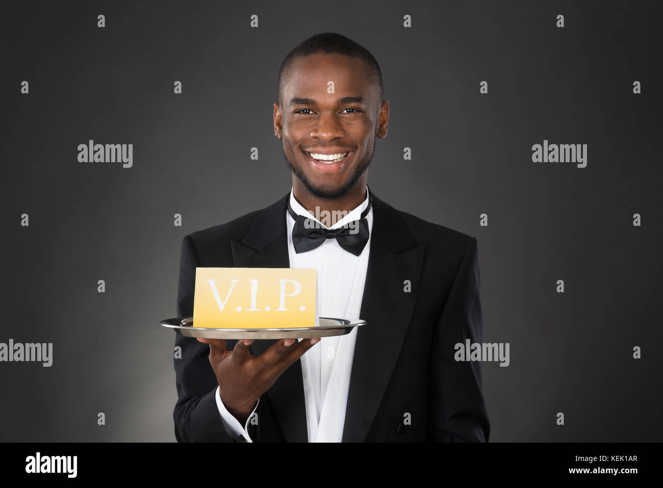 Happy African Waiter Holding Tray With VIP Sign Stock Photo - Alamy