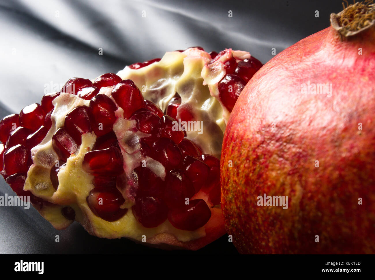 Big Pomegranate fruit fnd seeds on black background, closeup Stock ...