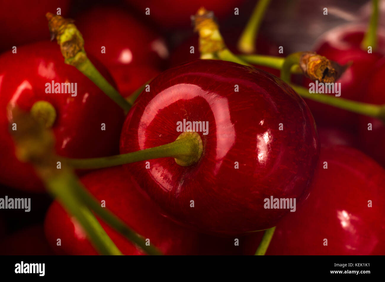 large ripe red sweet cherries in a dish of stainless steel, close-up ...