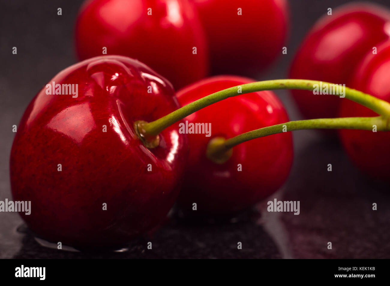 large ripe red sweet cherries in a dish of stainless steel, close-up ...