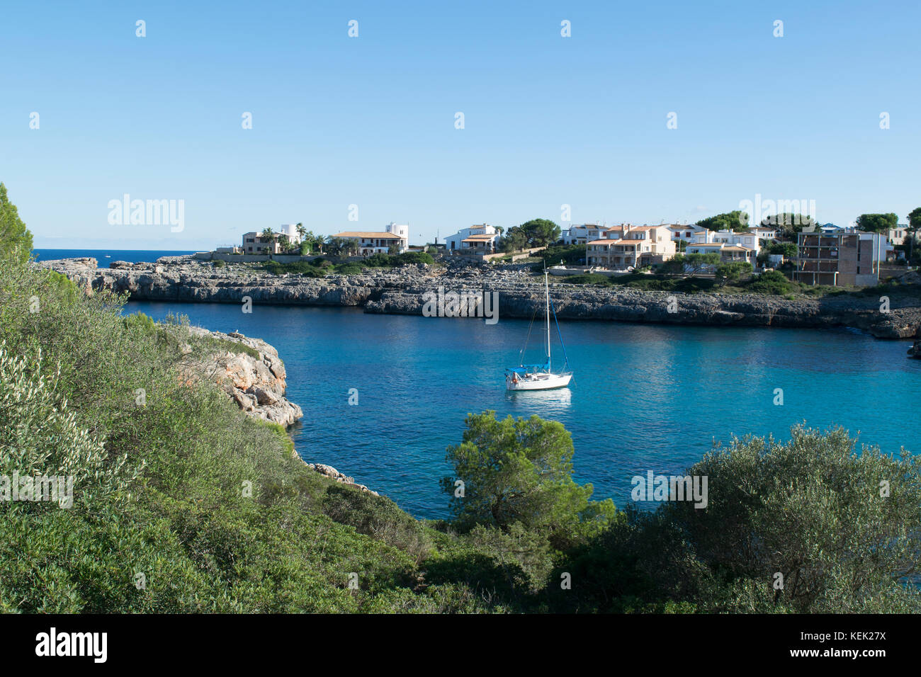 Boat sailing in Cala Marcal, a beautiful tourist area in the southeast ...