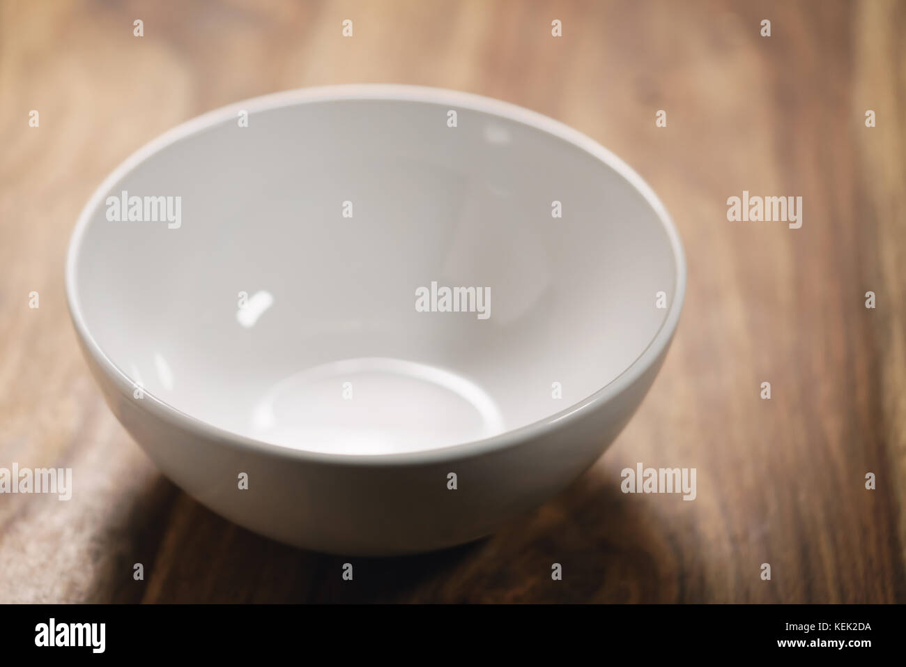 empty white bowl on wood table, shallow focus Stock Photo - Alamy