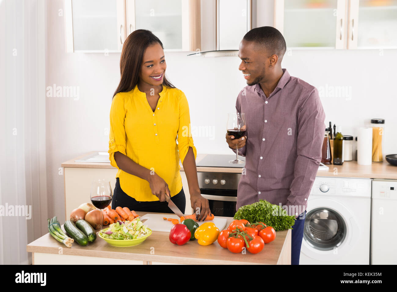 Young African Couple Cooking Food At Kitchen Stock Photo - Alamy