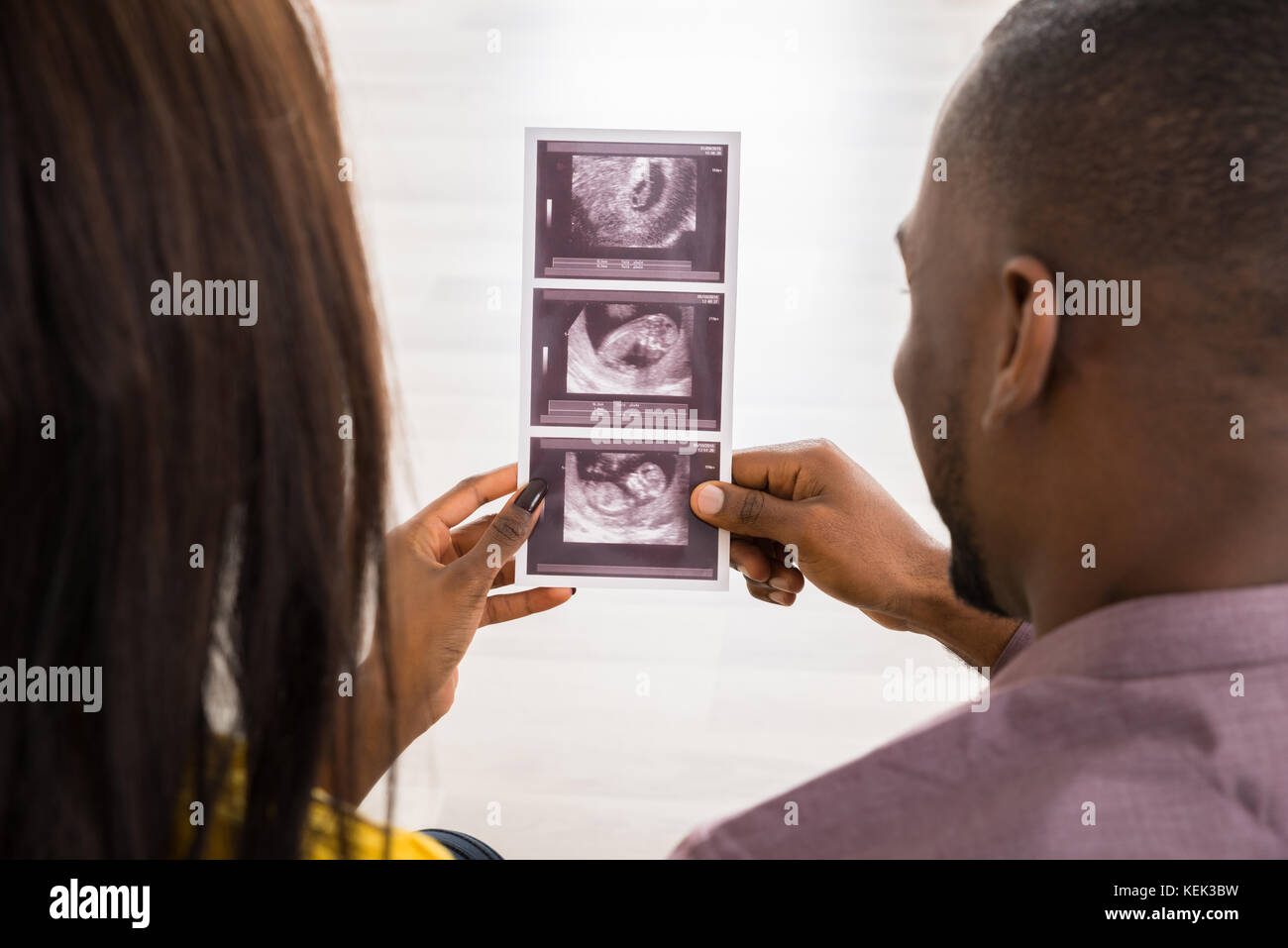 Close-up Of Young Expectant Couple Looking At Ultrasound Scan Report ...