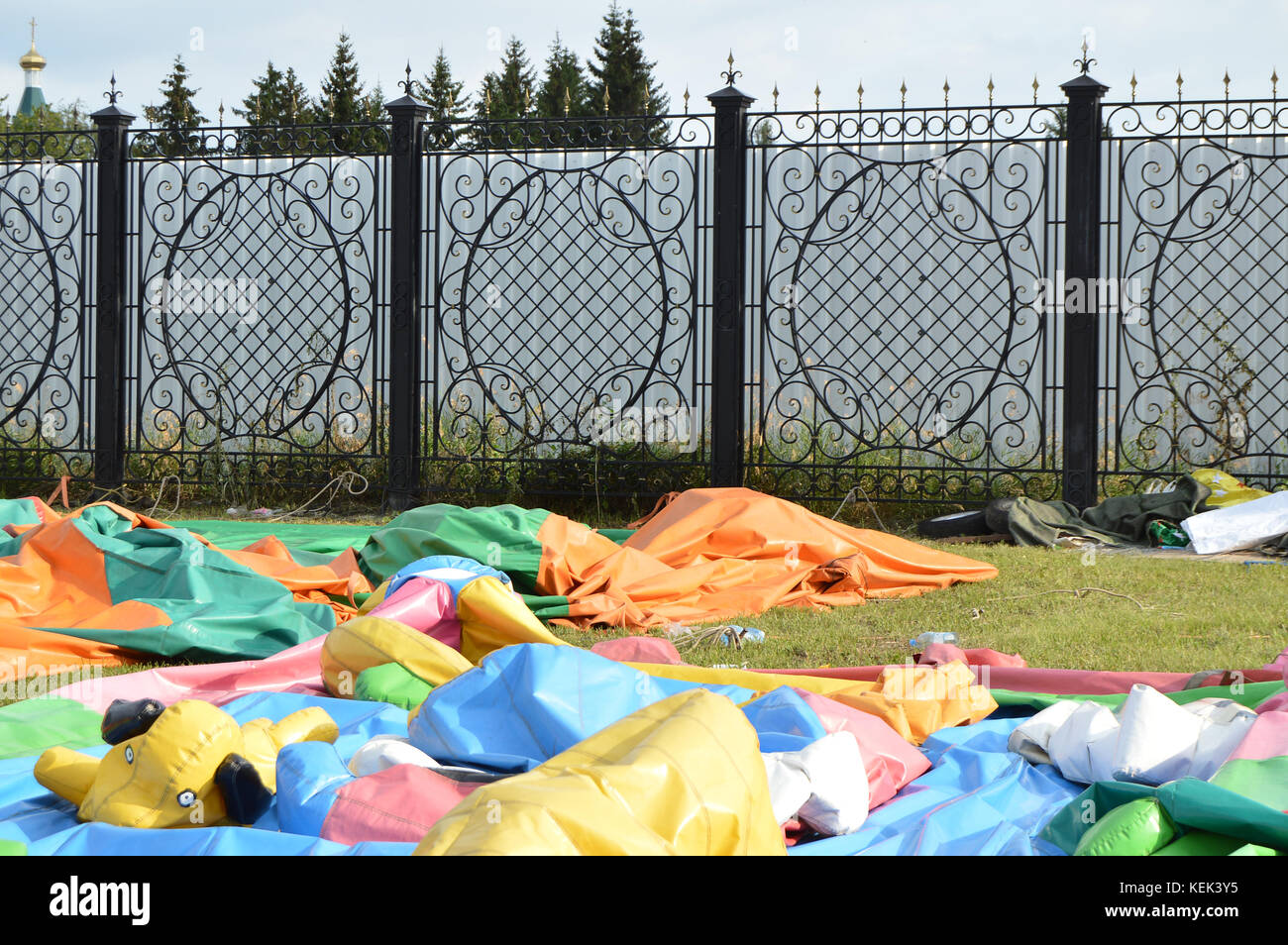 Colorful, large, inflatable children's slide on the green grass Stock ...
