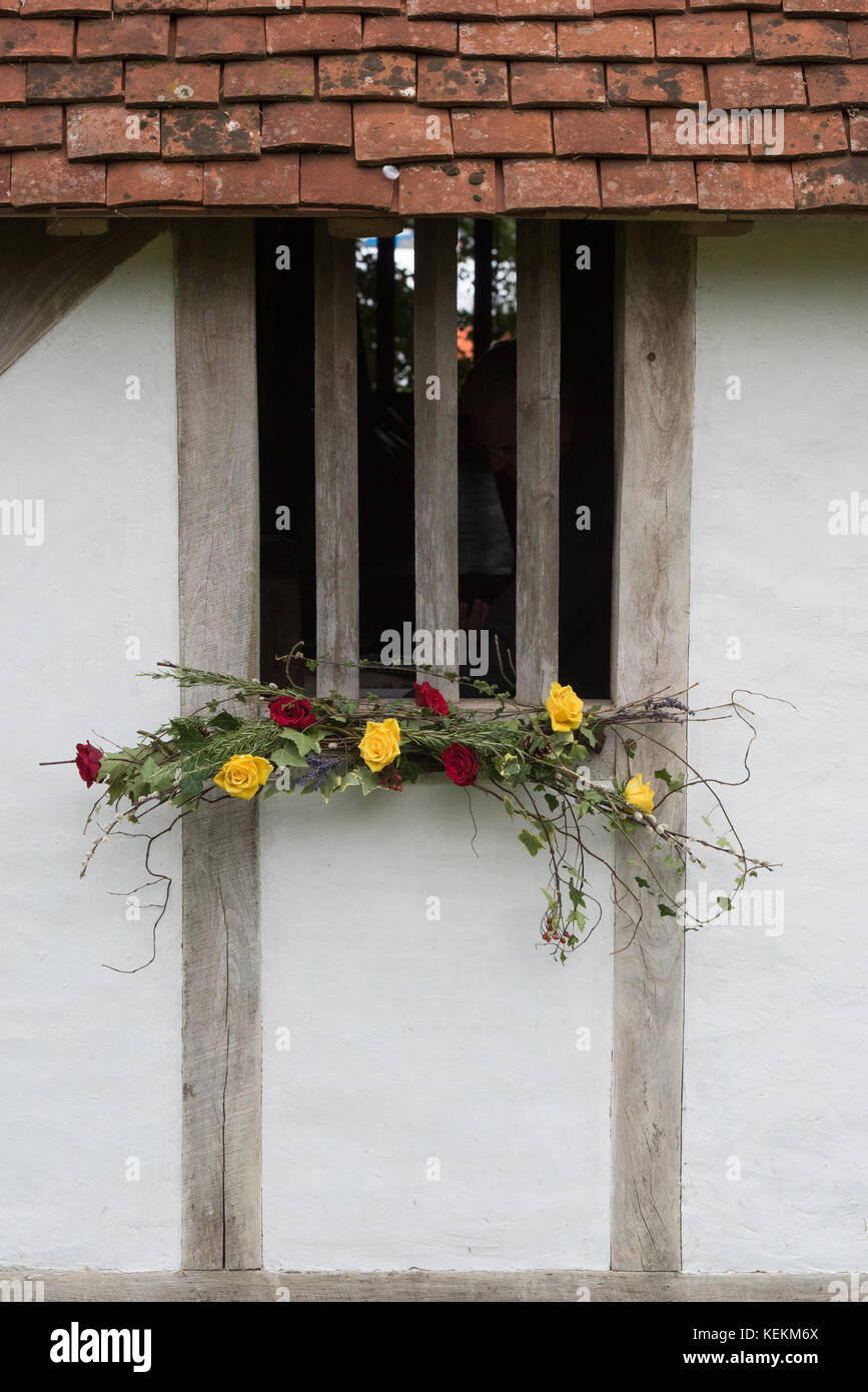 Autumn flower decoration on a medieval timber framed house window at ...