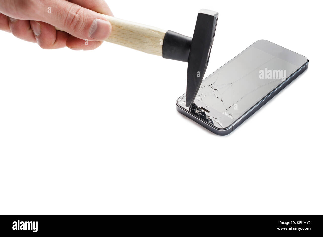 Male hand breaks a smartphone with a hammer against a white background ...