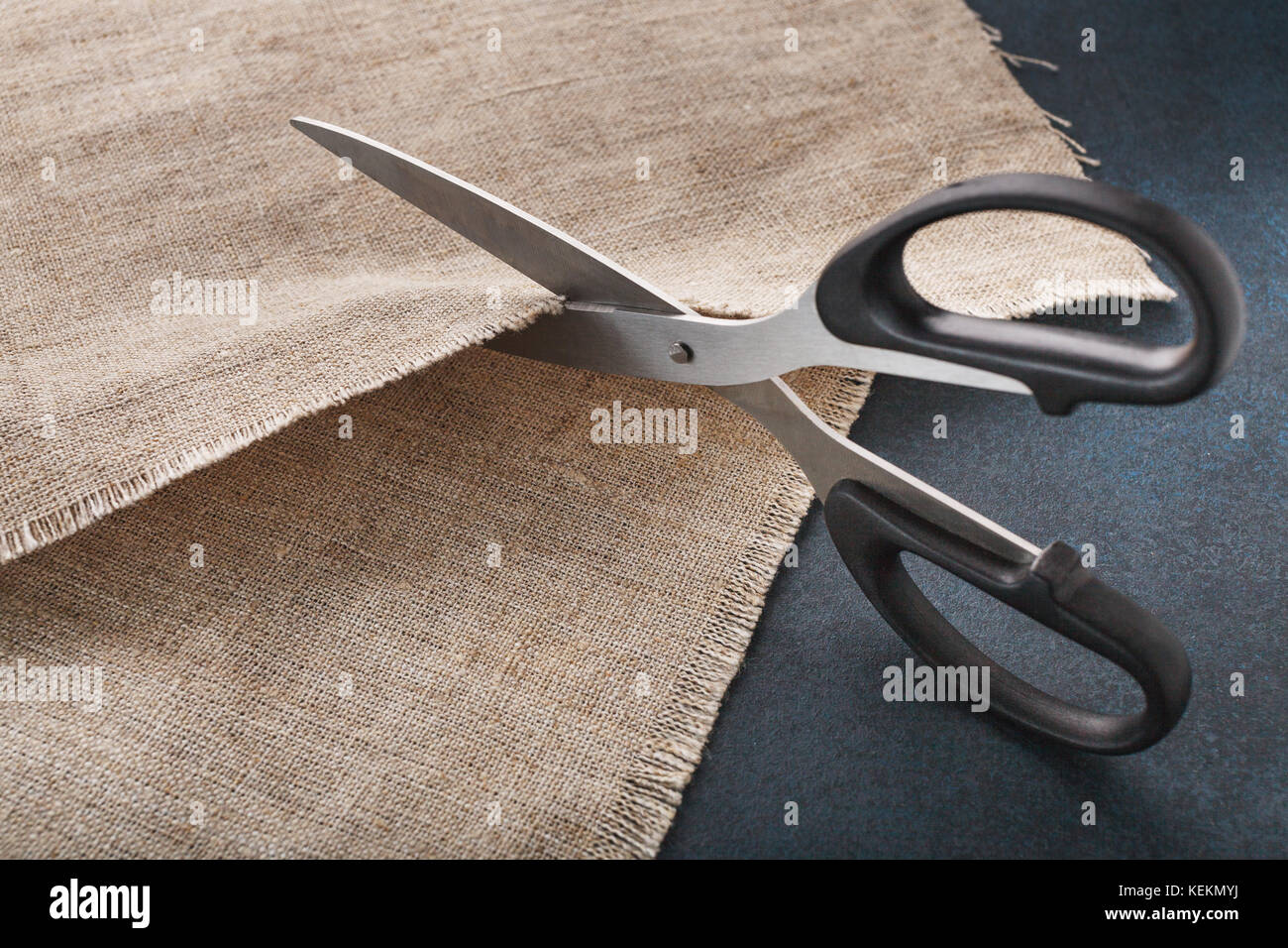 The tailor's scissors cut linen cloth Stock Photo - Alamy