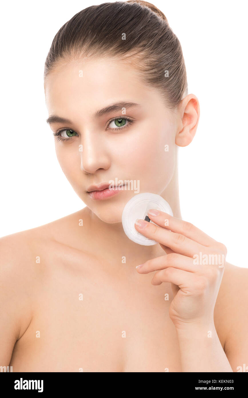 Young woman cares for face skin. Cleaning perfect fresh skin using cotton pad. Isolated Stock ...
