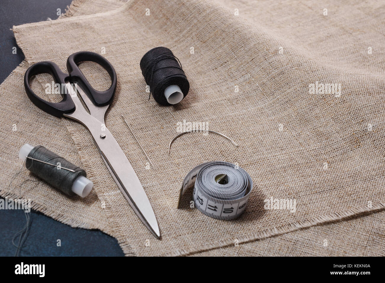 Sewing accessories on a background of canvas fabric Stock Photo - Alamy