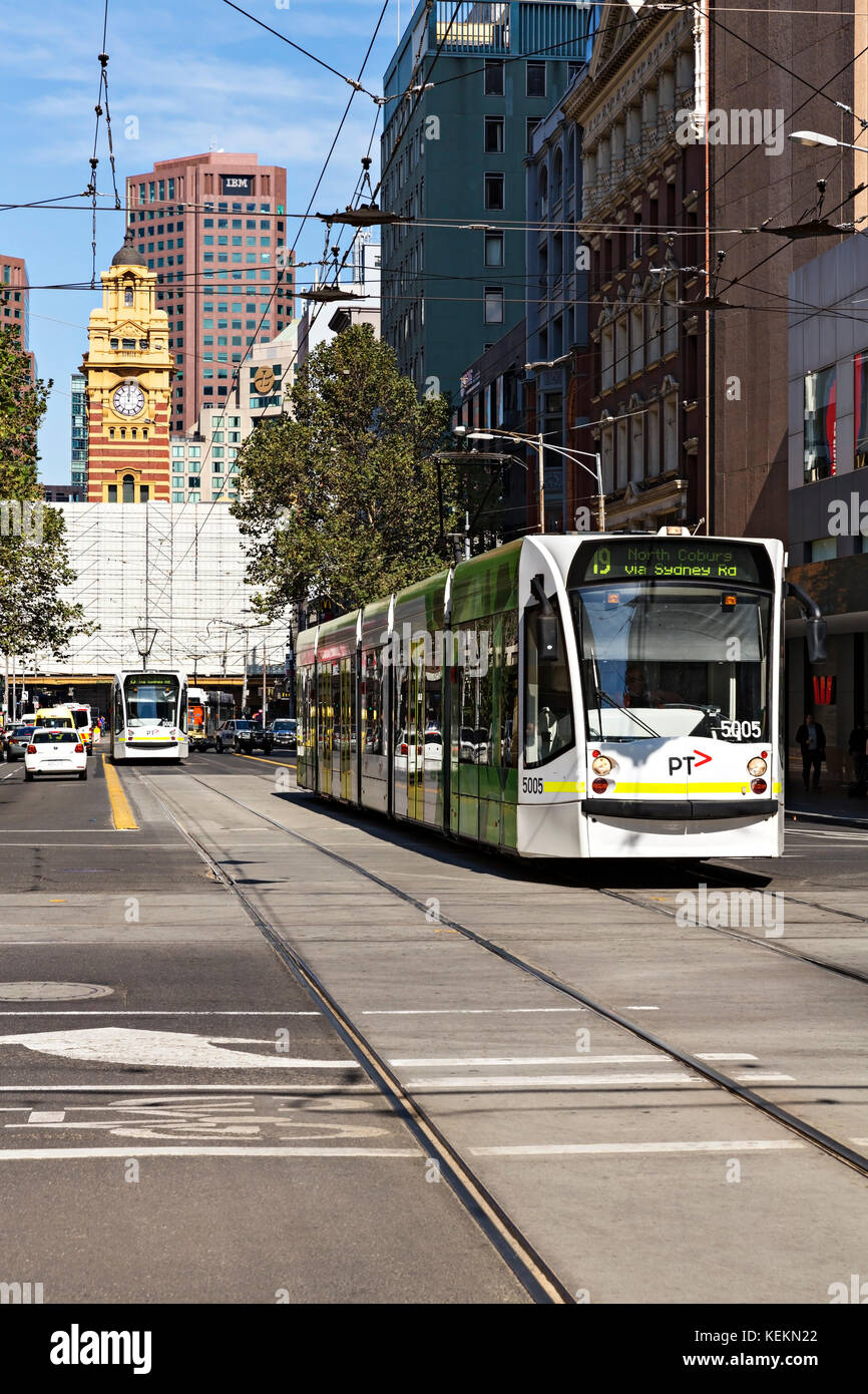 A modern tram travels along Elizabeth Street in Melbourne Victoria ...