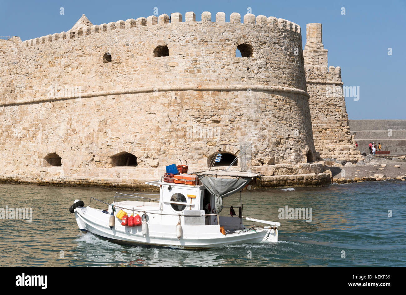 The Port of Heraklion, Crete, Greece, October 2017. The Venetian Fortress and small fishing boat ...