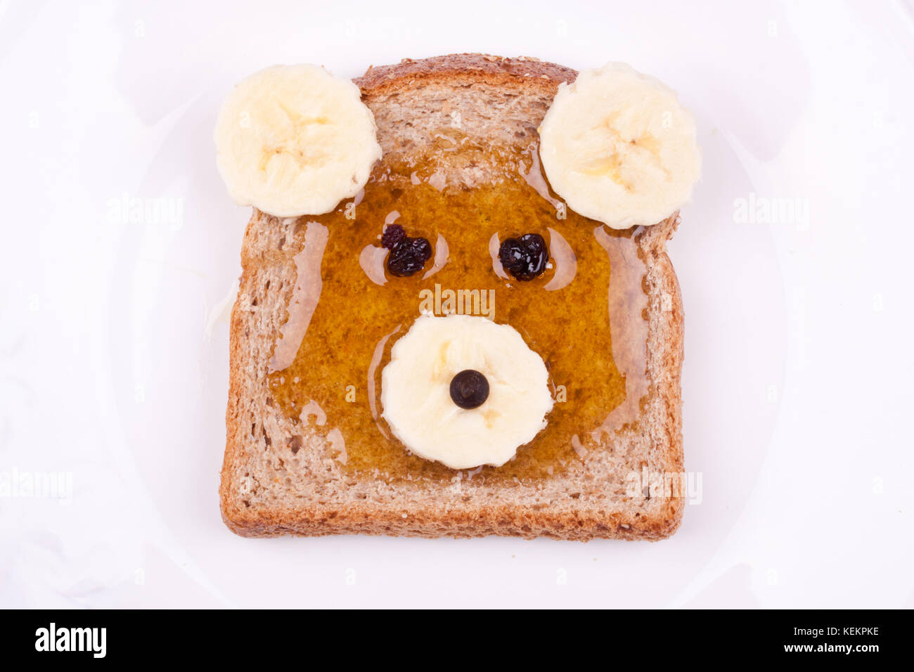bread slice with banana and homey , bear face shape Stock Photo - Alamy