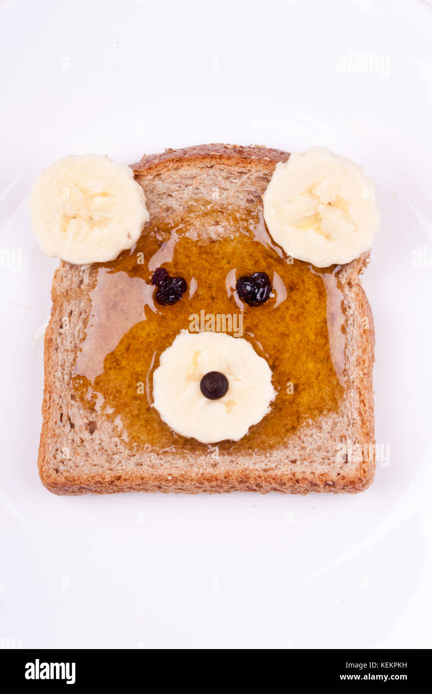 bread slice with banana and homey , bear face shape Stock Photo - Alamy