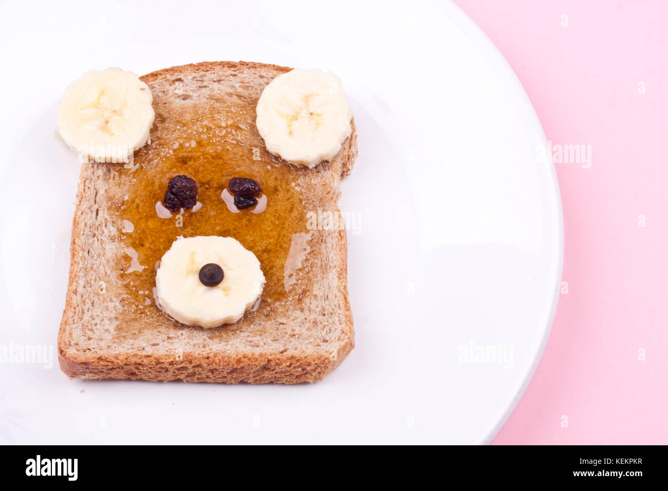bread slice with banana and homey , bear face shape Stock Photo - Alamy