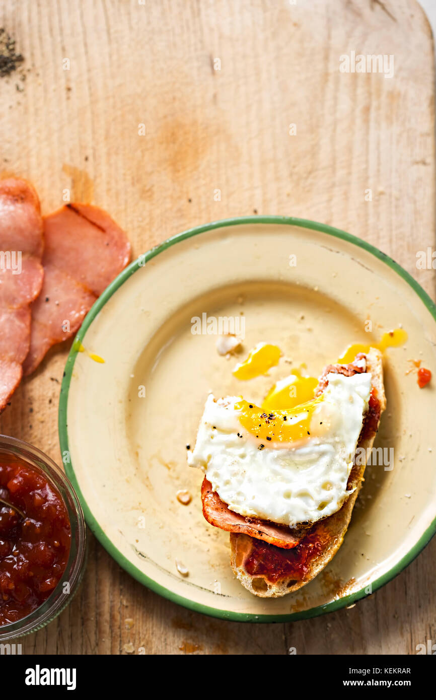 Bread slices with tomato relish, turkey rasher and fried egg Stock ...
