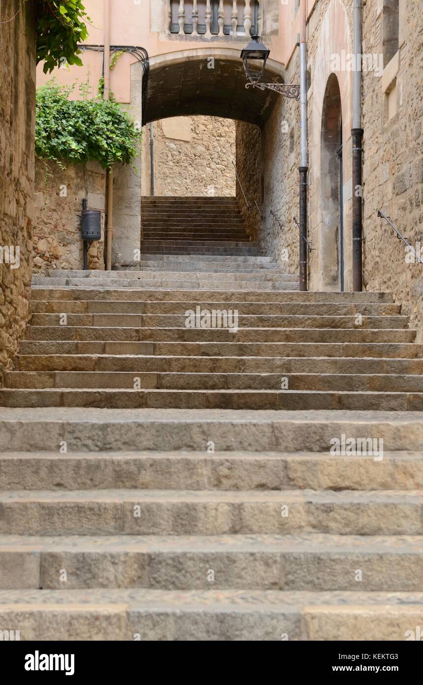 Stairs under stone archway in the old town of Girona, Catalonia ...