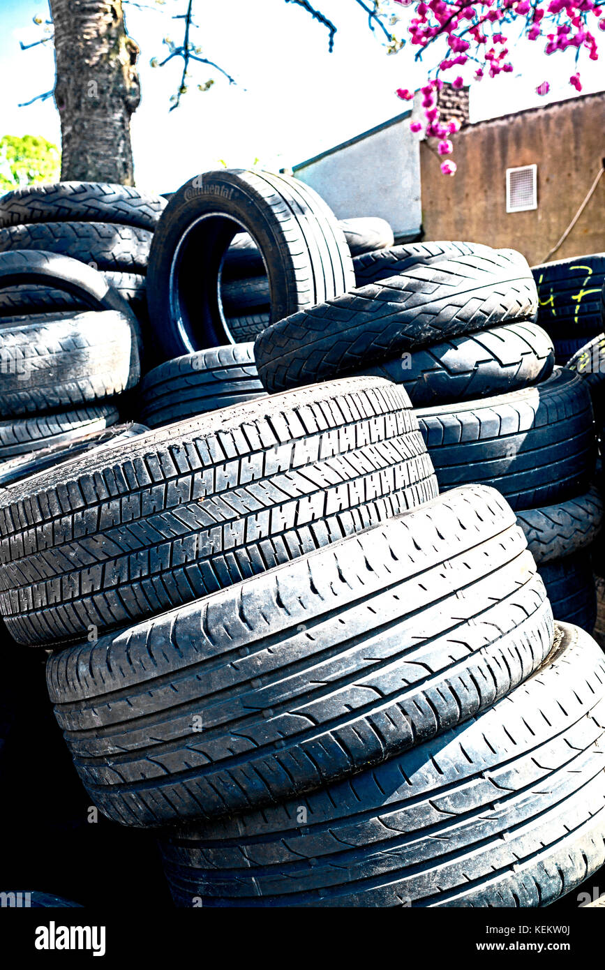 Pile of old Tyres in a shop Stock Photo - Alamy