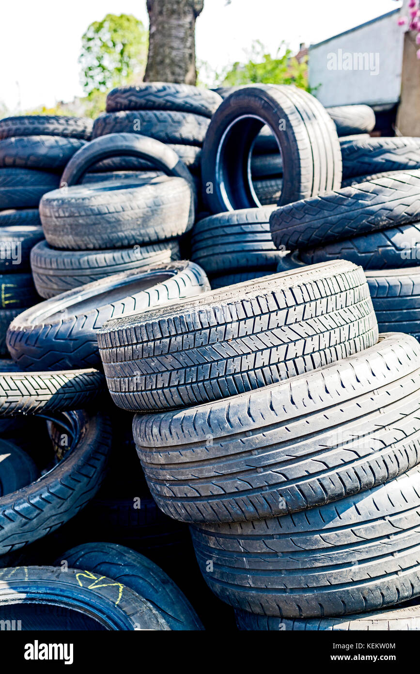 Pile of old Tyres in a shop Stock Photo - Alamy
