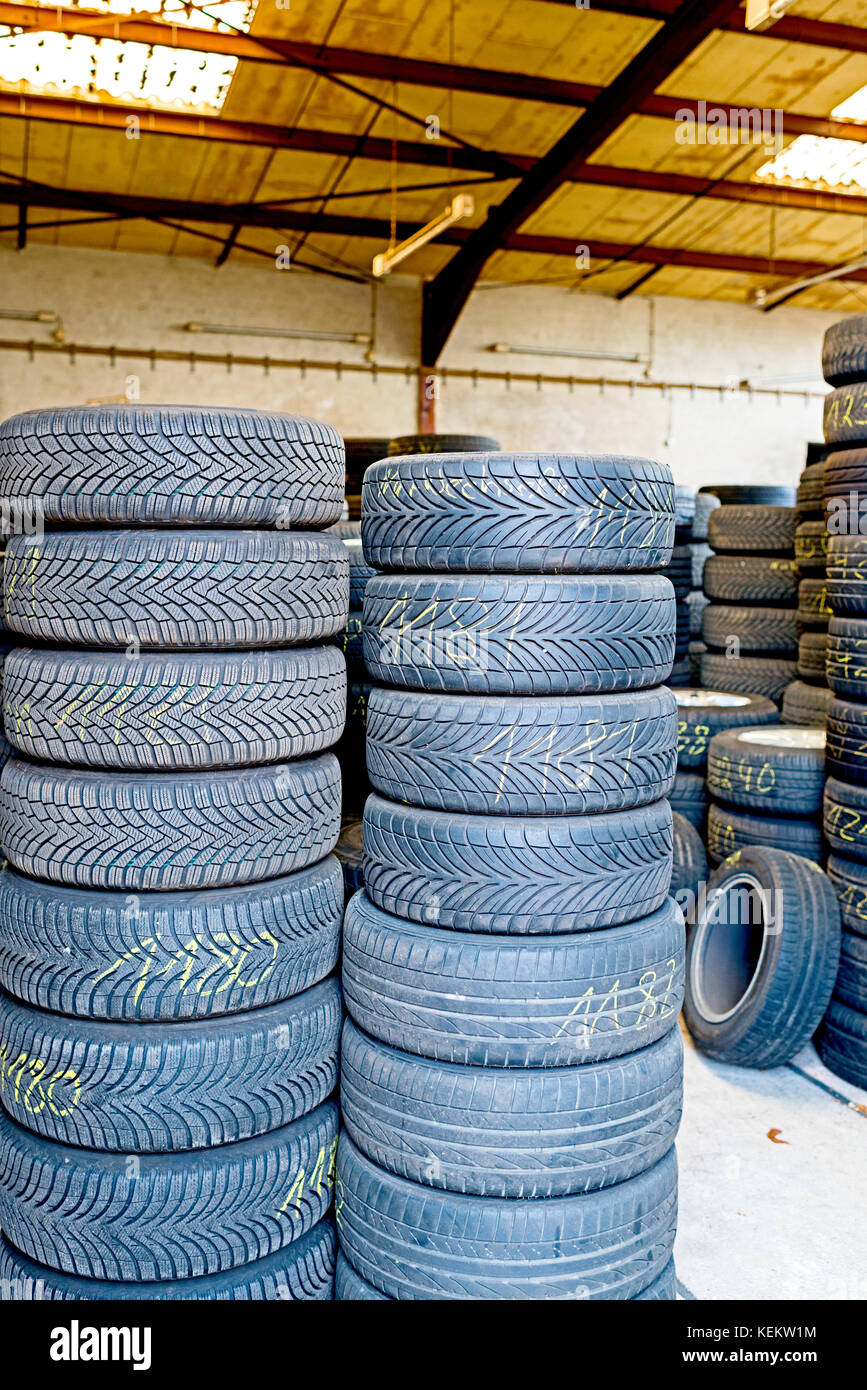 Pile of old Tyres in a shop Stock Photo - Alamy