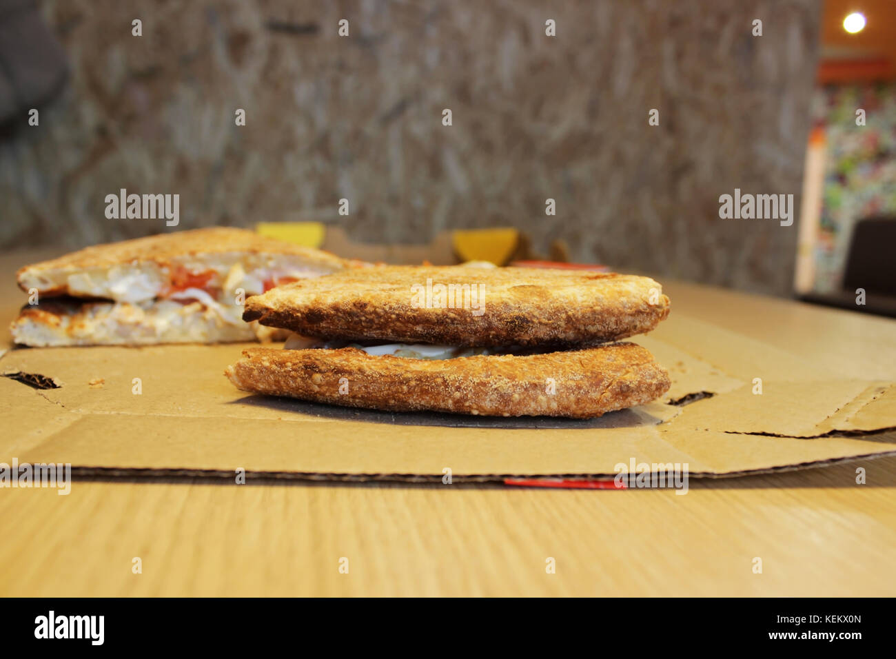 two appetizing ruddy slices of pizza lie on top of each other ...