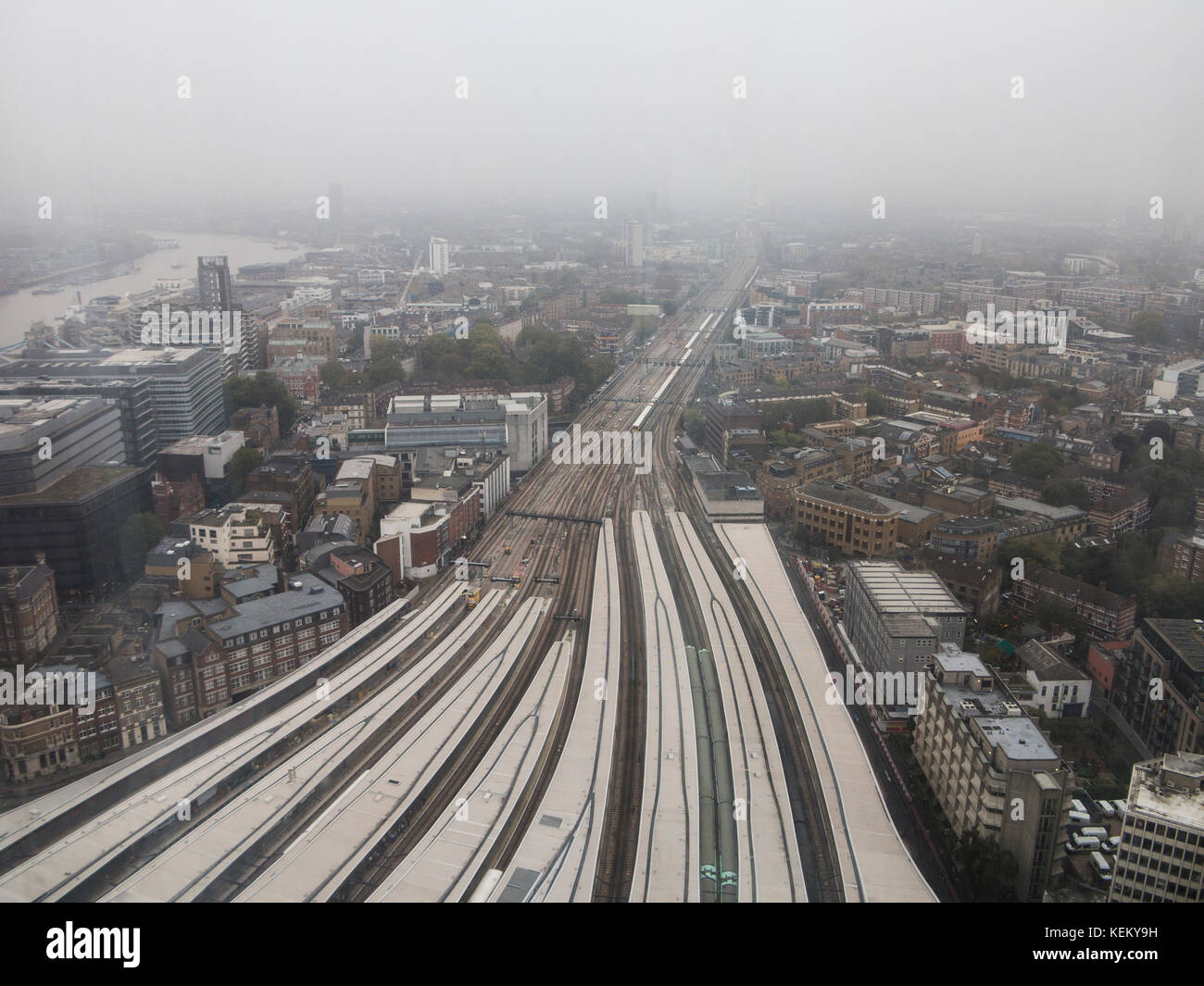 An aerial view of trains coming into London Bridge on a dull, foggy day ...