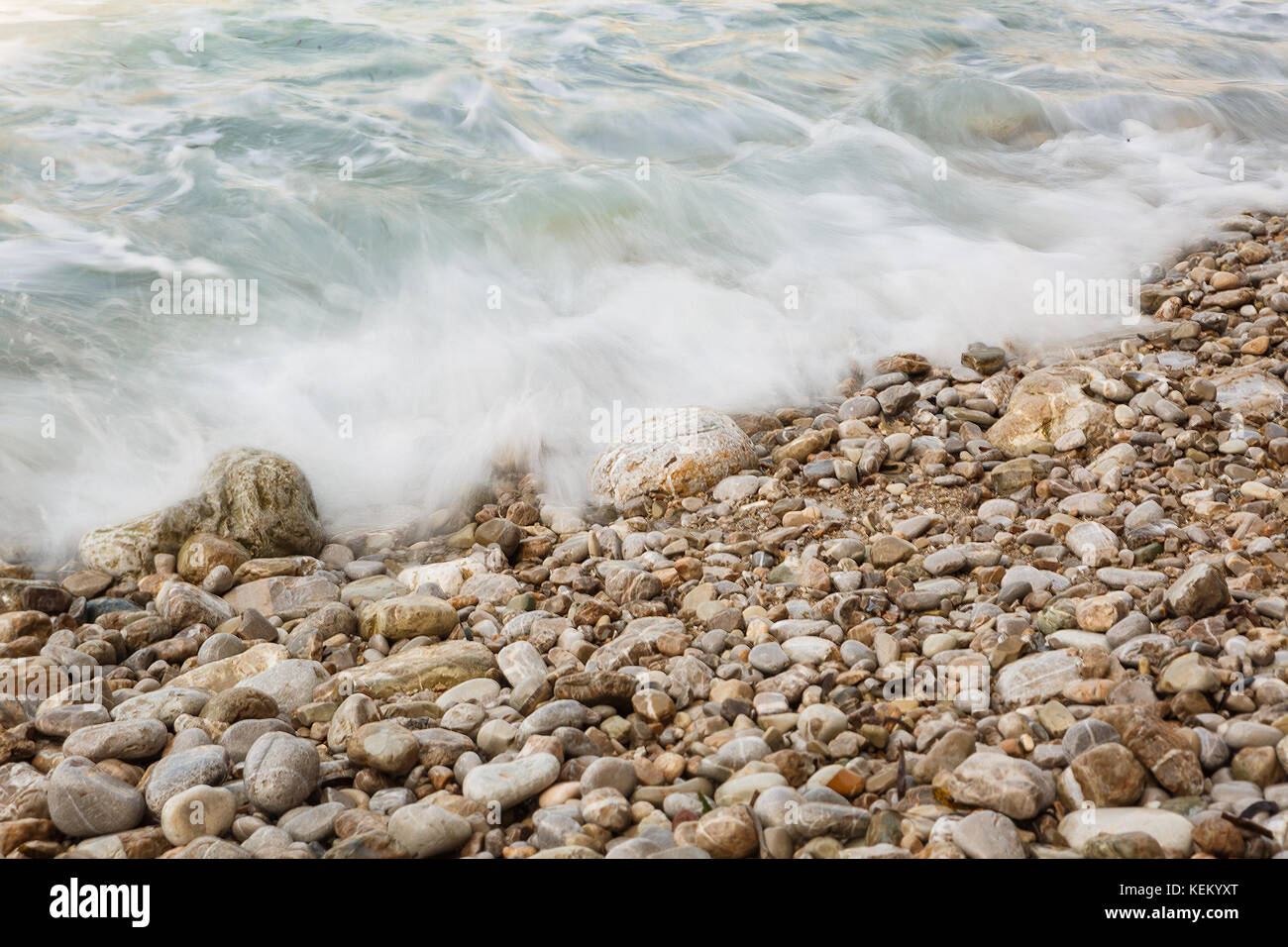Beautiful waves break against rocky hi-res stock photography and images ...
