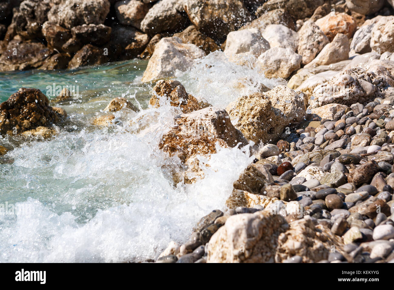 Beautiful waves break against rocky hi-res stock photography and images ...