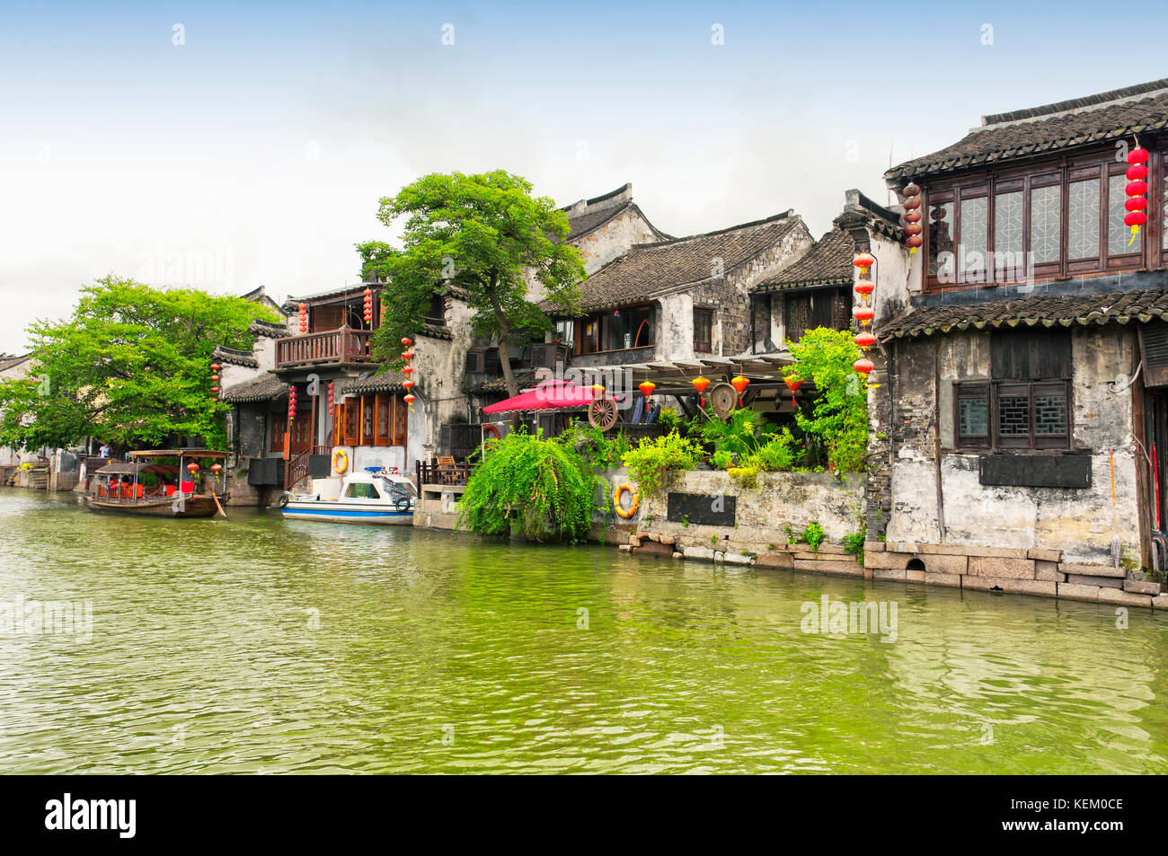 Chinese style buildings and tourist boats on the water canals of Xitang ...