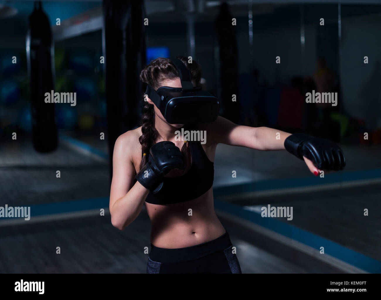 Young fighter boxer fit girl in VR glasses wearing boxing gloves Stock ...