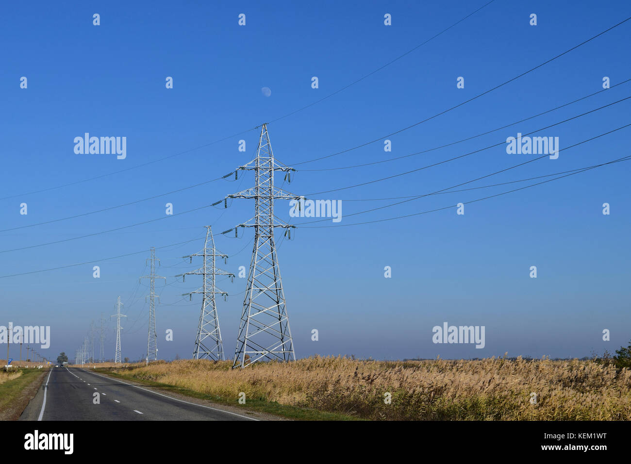 Support of electricity cables along the road. Country road Stock Photo ...