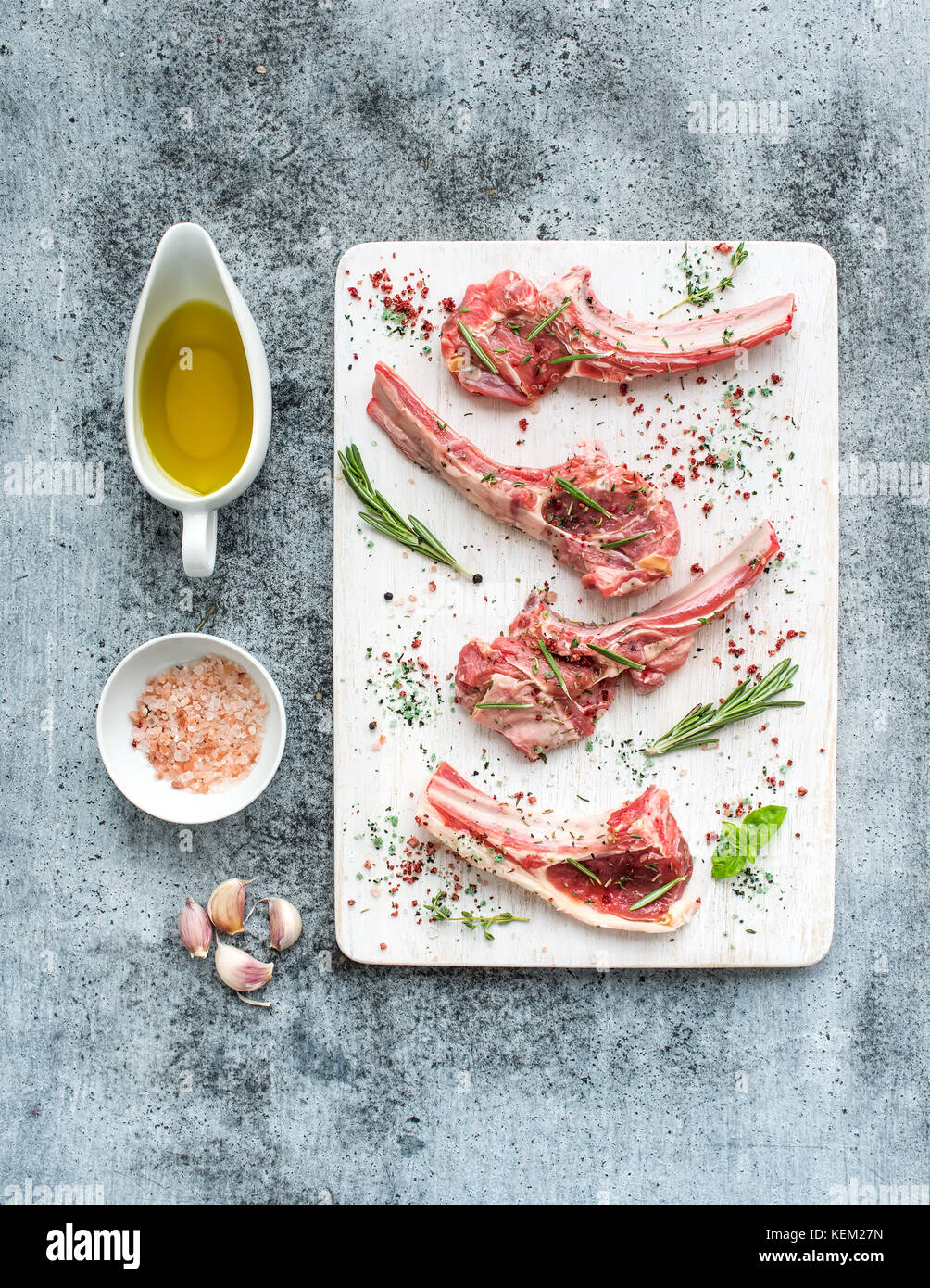 Raw lamb chops. Rack of Lamb with garlic, rosemary and spices on black ...