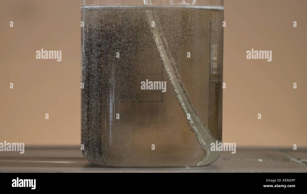 Test tube close up. Black liquid in the flask. The liquid in the flask ...
