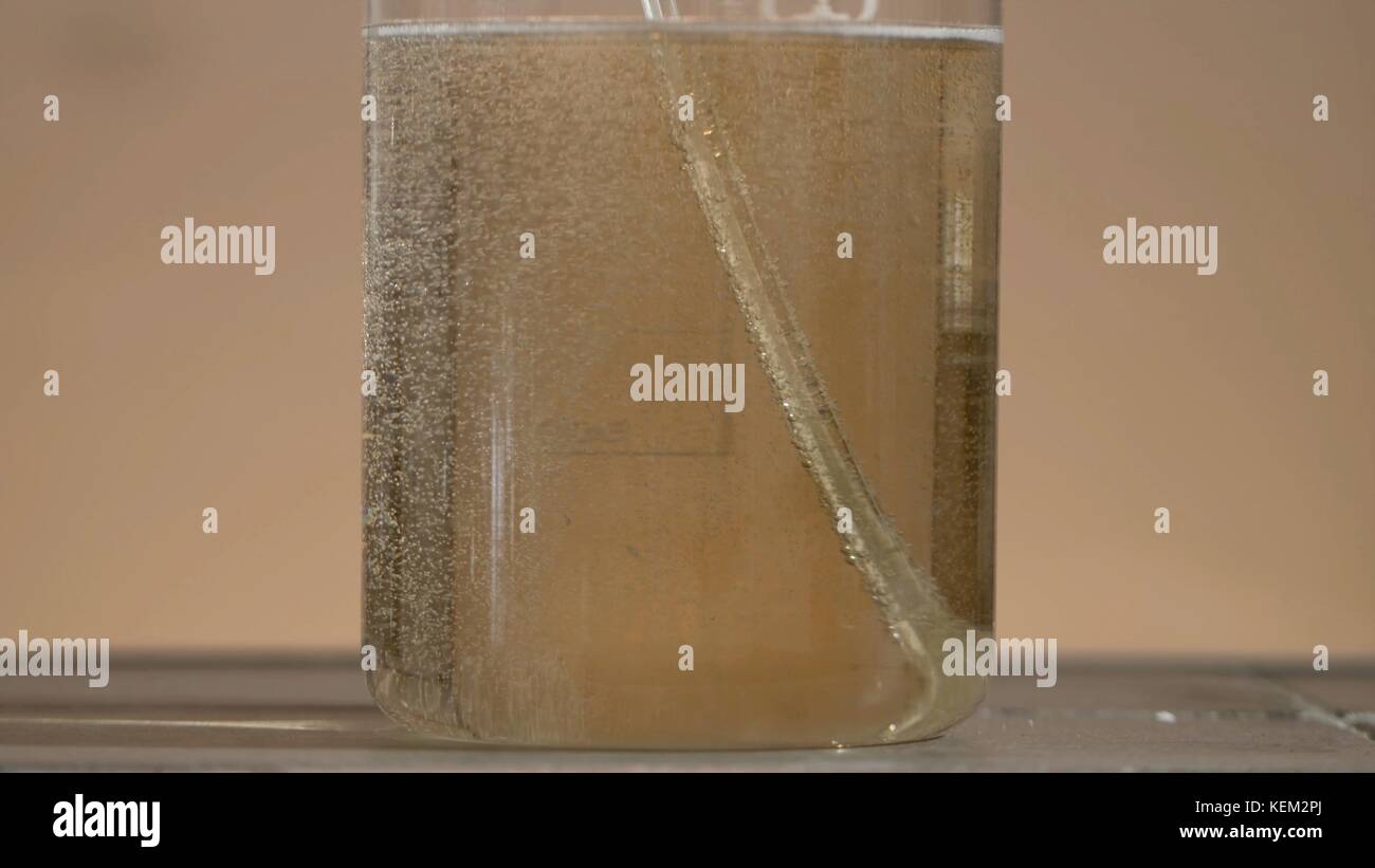 Test tube close up. Black liquid in the flask. The liquid in the flask ...