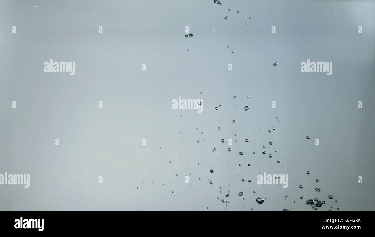 Close up water bubbles on glass gray background. Water bubbles in a ...