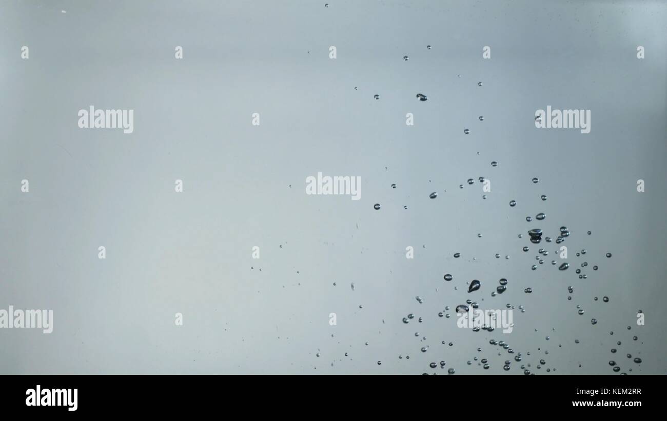 Close up water bubbles on glass gray background. Water bubbles in a ...