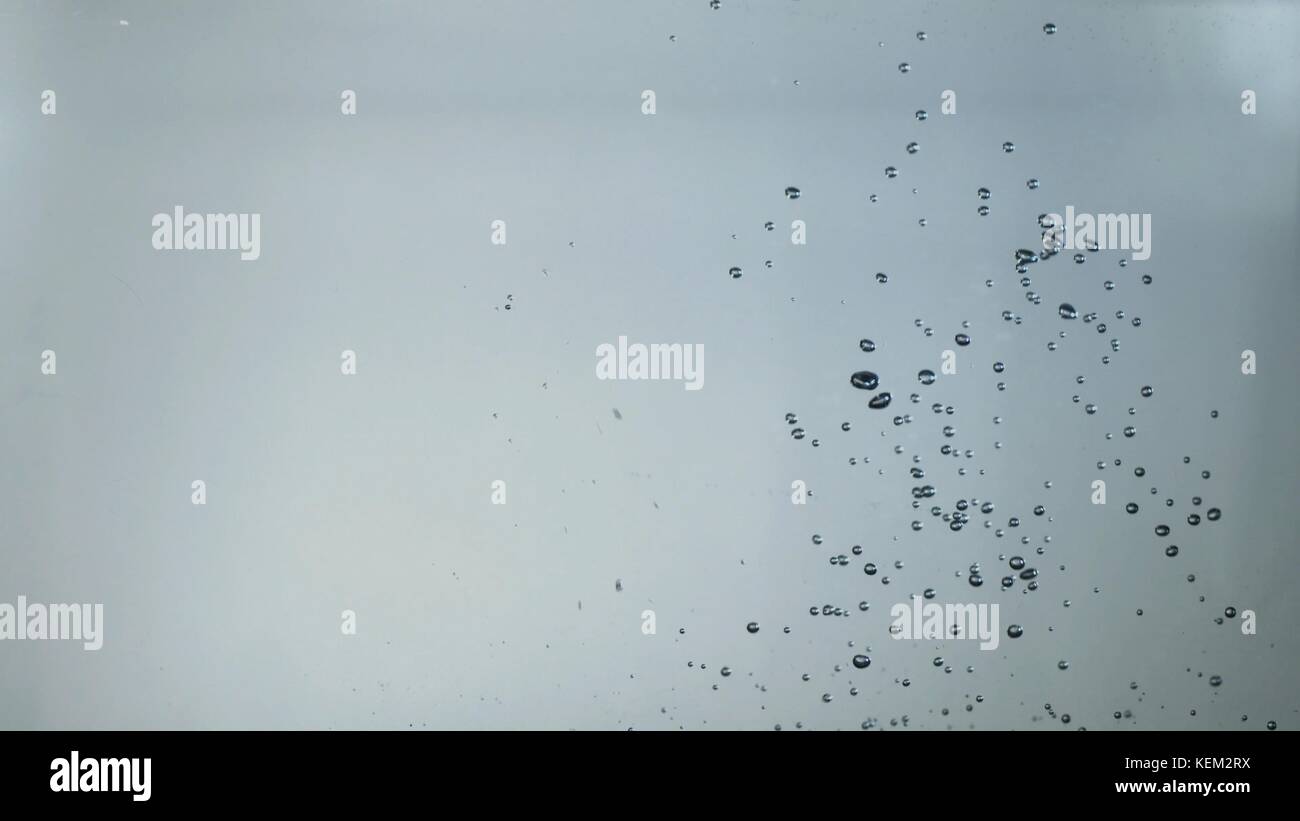 Close up water bubbles on glass gray background. Water bubbles in a ...
