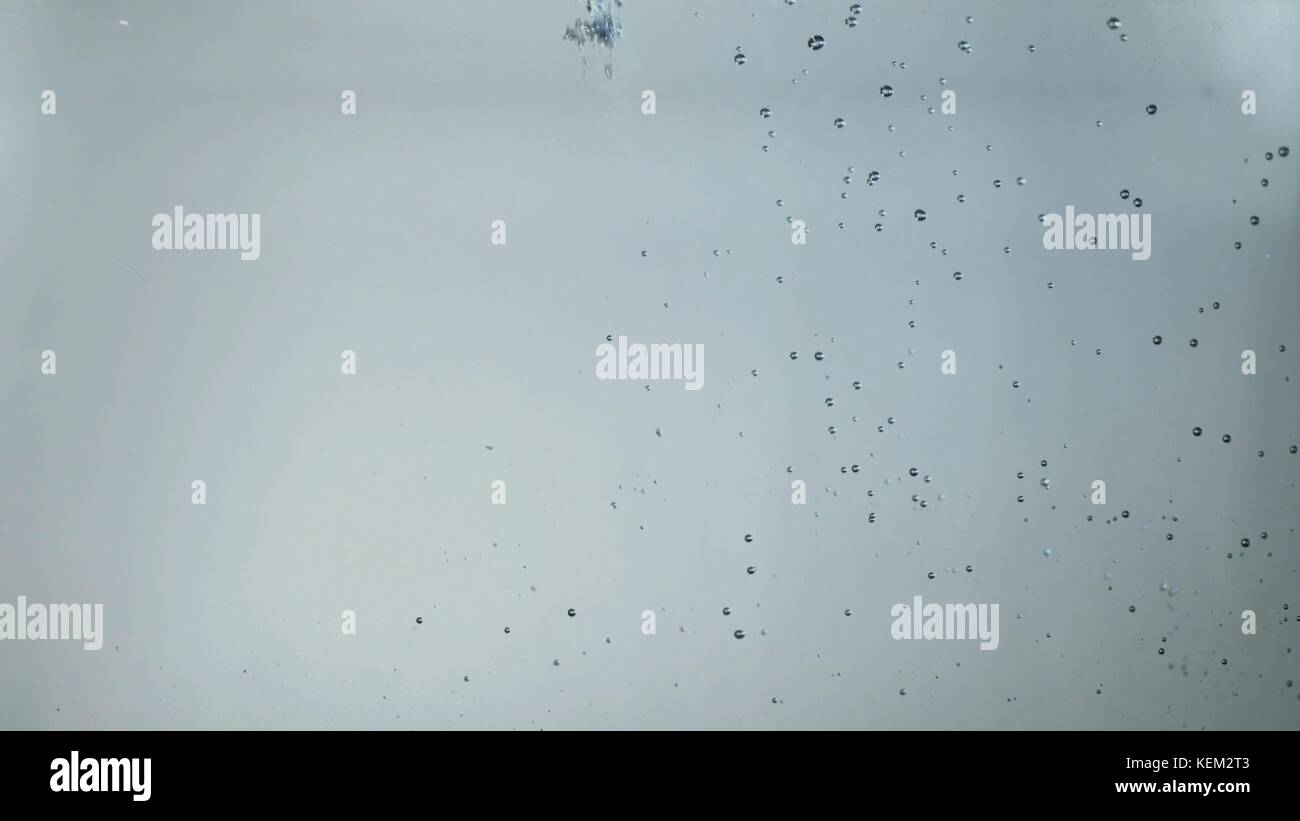 Close up water bubbles on glass gray background. Water bubbles in a ...