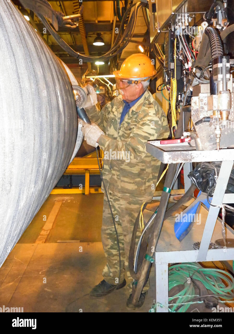 Weld preparation before installation. Workers clean the place of ...