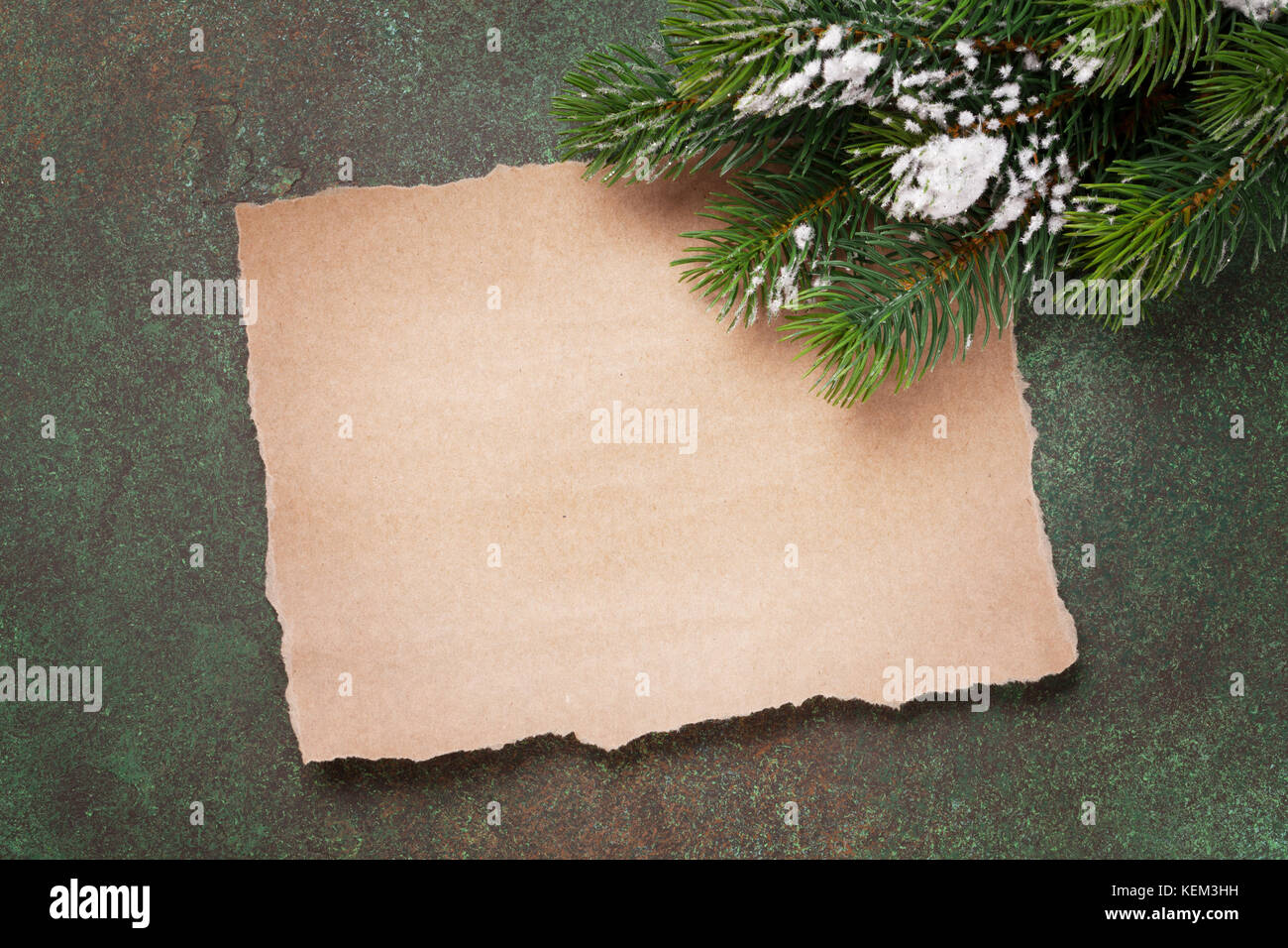 Piece of paper for christmas wishes and snow xmas tree. Top view with ...